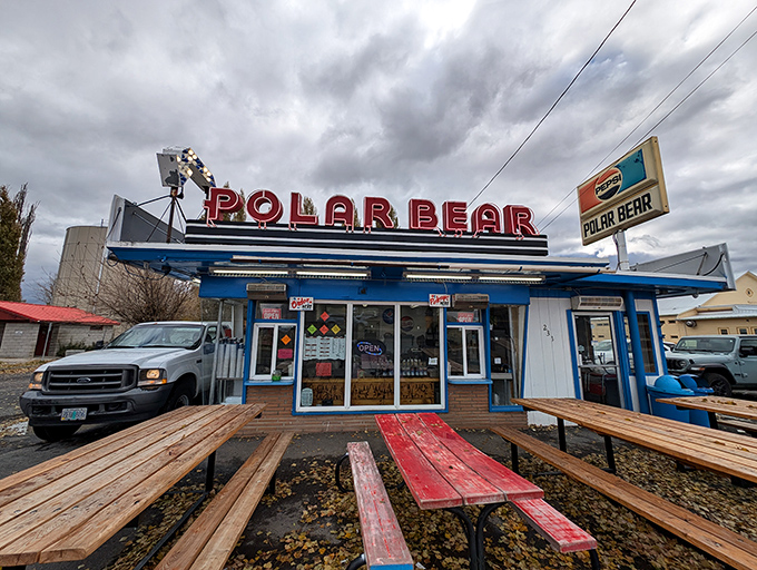 The iconic Polar Bear stands proudly against Merrill's water tower, its vintage neon sign promising cold treats in a warm welcome.