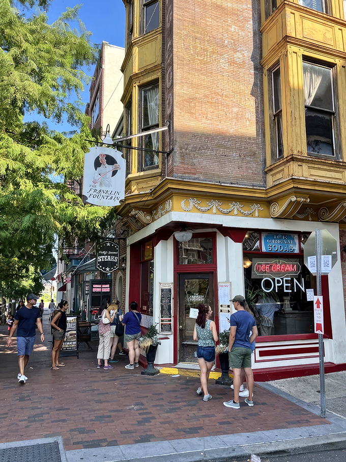 The storefront beckons like a time portal to ice cream's golden age&mdash;ornate yellow cornice, classic signage, and that brick facade promising sweet nostalgia inside.
