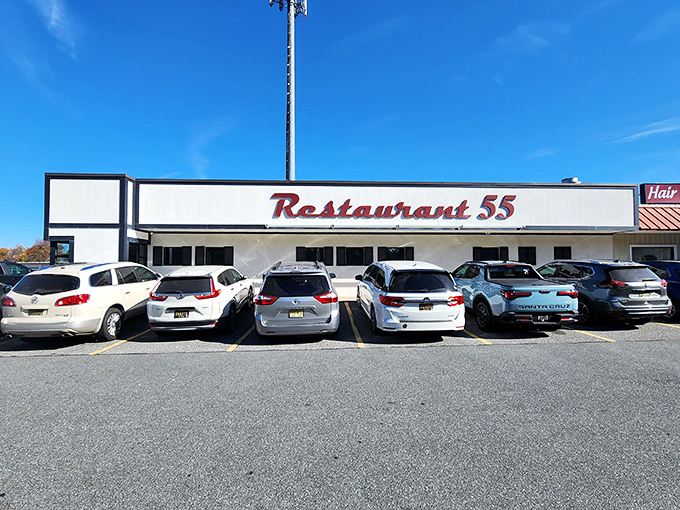 The classic red script signage welcomes you like an old friend. That vintage Mercedes in the parking lot suggests you're not the only one with good taste.