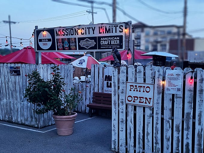 The outdoor patio at R.J.'s beckons with rustic charm, string lights, and red umbrellas &ndash; a perfect summer sanctuary for barbecue enthusiasts seeking open-air feasting.