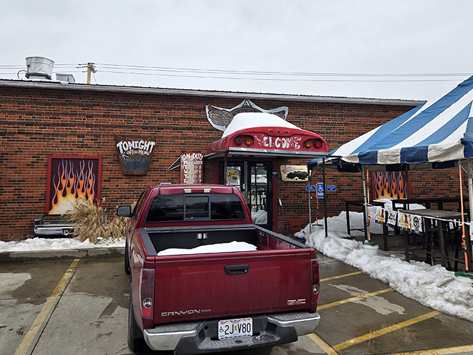 The unassuming brick exterior promises barbecue greatness with its cheeky welcome sign and flame-adorned entryway. Meat paradise awaits. 