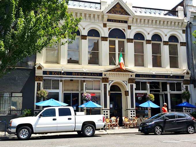 The historic fa&ccedil;ade of Kells stands proudly in Portland, complete with Irish flag and inviting blue umbrellas beckoning passersby to step into Dublin-on-the-Willamette. 