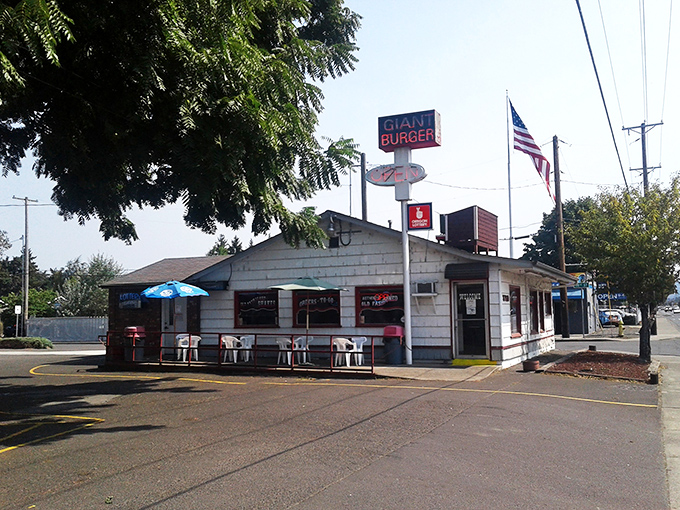 The unassuming white clapboard exterior of Giant Burger stands like a time capsule, its bold red sign promising exactly what generations of Oregonians have come to crave. 