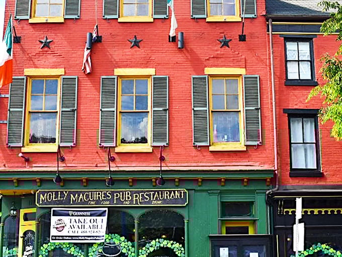 The warm brick exterior of Molly Maguire's glows at twilight, with the iconic Guinness sign promising authentic Irish hospitality within. 