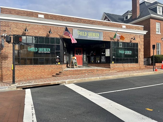 The brick facade of The Auld Shebeen stands proudly on Fairfax's Main Street, American and Irish flags waving in harmony like old friends sharing stories.