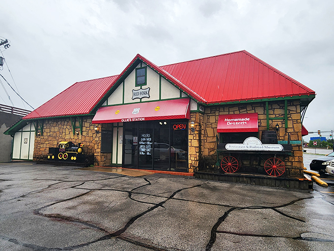 The stone exterior of Ollie's Station Restaurant stands like a welcoming depot, complete with vintage railway wagon and distinctive red roof that signals culinary adventures ahead.