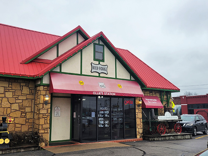 The stone exterior of Ollie's Station Restaurant stands like a welcoming depot, complete with vintage railway wagon and distinctive red roof that signals culinary adventures ahead.