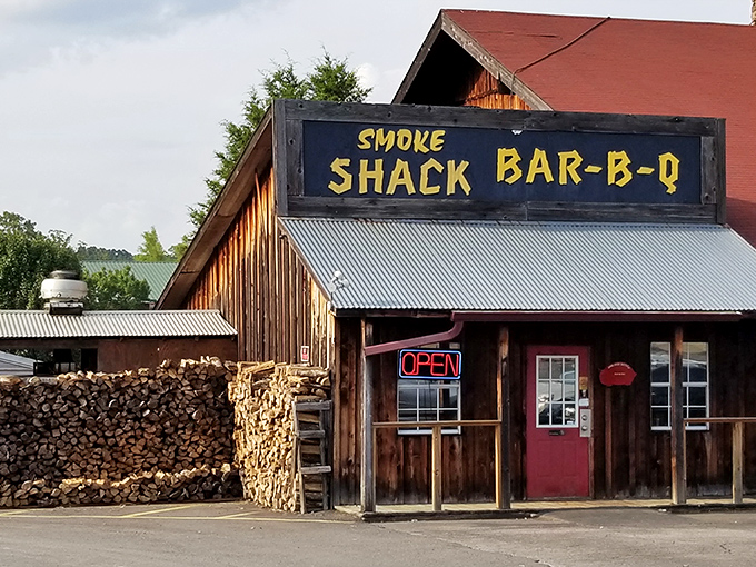 That hand-painted yellow sign against weathered wood isn't just decoration&mdash;it's a promise of smoky delights waiting behind that bright red door.