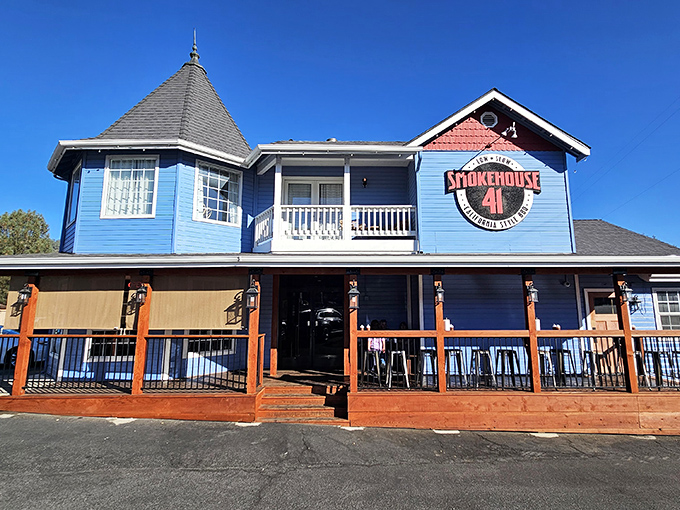 The blue Victorian-style building housing Smokehouse 41 stands like a beacon of barbecue hope in Oakhurst, promising smoky treasures within its welcoming walls.