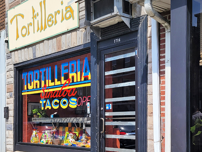 The storefront announces itself with vibrant blue, red, and yellow lettering that seems to say, "Yes, this is the real deal." Colorful ceramic pitchers in the window hint at the authenticity waiting inside.