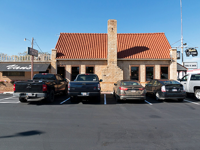 The iconic orange roof and stone exterior of Van's Pig Stand stands as a beacon of barbecue hope on Shawnee's horizon, promising smoky delights within.
