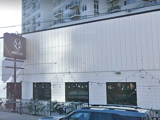 The unassuming white exterior of Marble Fox Brewing Company stands like a blank canvas, hiding the flavor explosion waiting inside. Nashville's best-kept liquid secret.