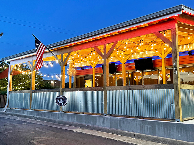 The glow on Rocky Mount Smokehouse's patio feels like a barbecue beacon calling you home. String lights and American pride included.