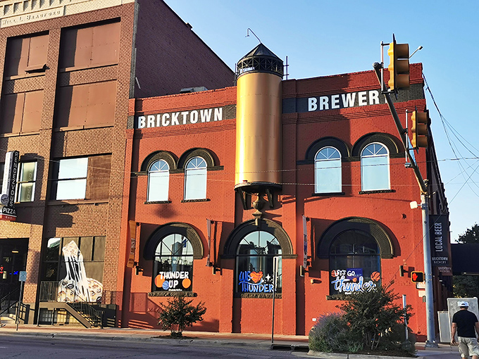 The iconic red brick exterior of Bricktown Brewery stands as a beacon of culinary promise in Oklahoma City's historic district, where industrial charm meets modern appetite.