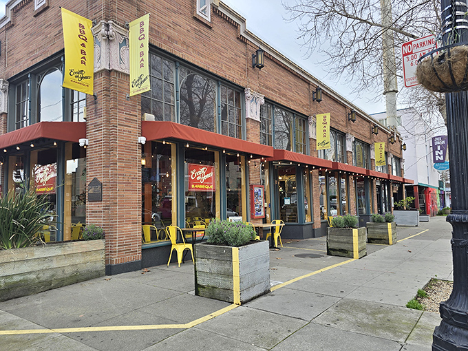 The bright orange awning and cheerful yellow chairs are like a beacon calling to barbecue pilgrims on Oakland's Broadway. Welcome to flavor town.