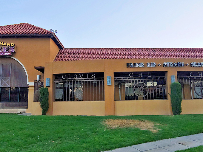 The Western-themed exterior of Cool Hand Luke's beckons with its iconic cactus sentinels and vintage wagon&mdash;like stepping onto a movie set where dinner is the star attraction.