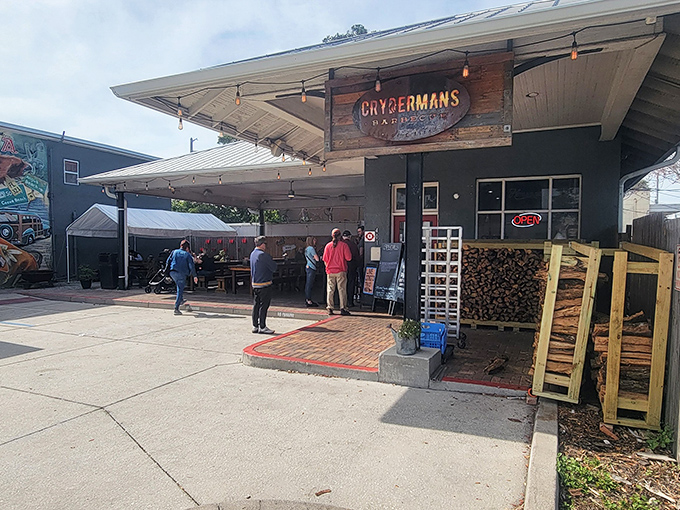 The unassuming exterior of Crydermans hides barbecue greatness like a superhero's secret identity. Stacked firewood isn't decor&mdash;it's a promise of smoky deliciousness to come.