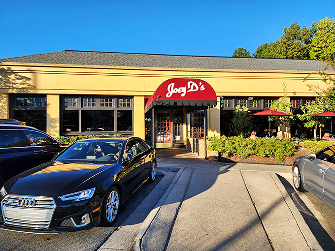 The iconic burgundy awning of Joey D's beckons like a culinary lighthouse in Dunwoody, promising comfort and indulgence just steps from the parking lot.