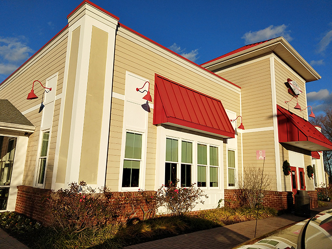 The unassuming exterior of Adams Grille & Tap House with its signature red roof beckons like a barbecue lighthouse guiding hungry travelers home.