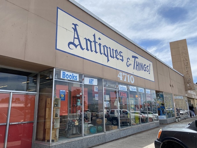 The storefront beckons with promises of treasures within, its blue lettering against beige like a desert sky invitation to explore.