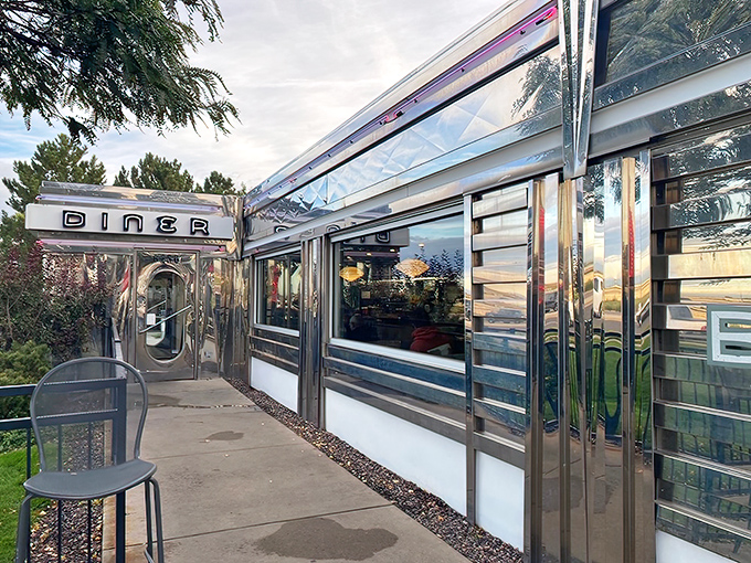 That neon sign doesn't whisper&mdash;it announces with retro swagger: "Hungry humans, your comfort food paradise awaits!" The turquoise and red color scheme practically sings against the Colorado sky.