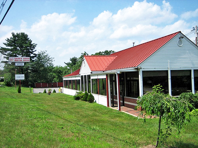 The iconic Vic's Waffle House sign stands tall against the Massachusetts sky, beckoning hungry travelers with promises of breakfast bliss and maple-drenched dreams.