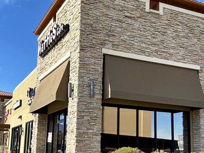 The stone facade of Waffles Cafe stands like a humble temple to breakfast, promising griddle-based salvation away from the neon chaos of the Strip.