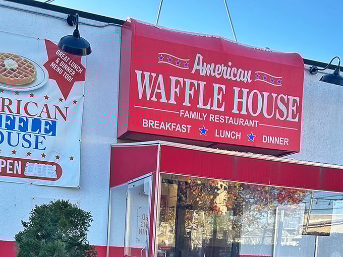 The bright red exterior of American Waffle House stands like a beacon of breakfast hope on Merrick Road. Resistance is futile.