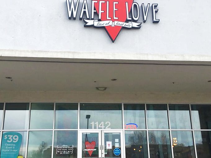 The bright red heart logo of Waffle Love beckons from the storefront like a siren song for breakfast enthusiasts. Your waffle journey begins here.