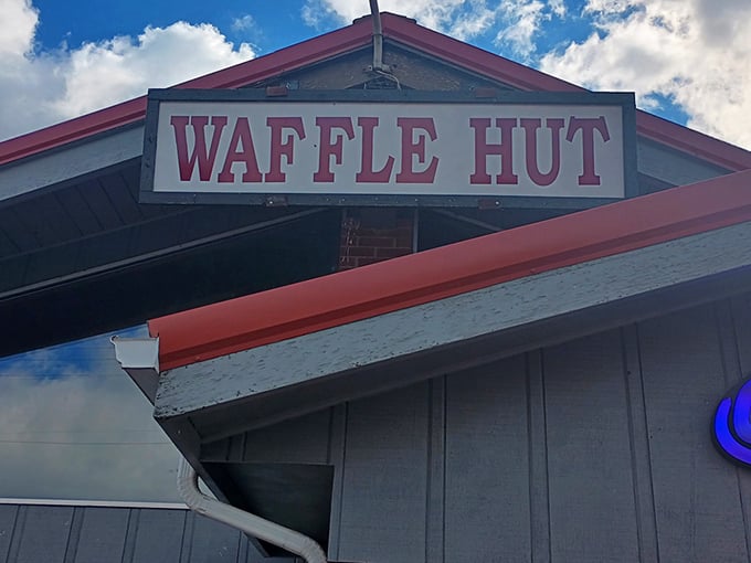 The modest sign says "WAFFLE HUT" but might as well read "Breakfast Paradise Ahead." Sometimes the most unassuming exteriors hide the greatest culinary treasures.