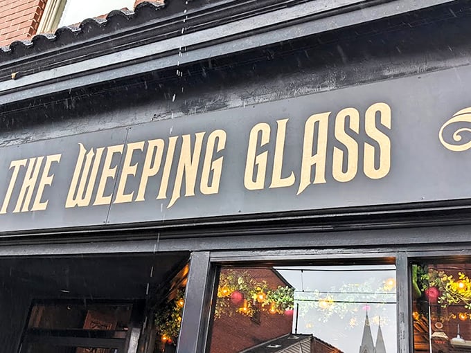 The Weeping Glass beckons curious passersby with gold lettering that promises "ODDITIES" and "CURIOSITIES" &ndash; an invitation few can resist.
