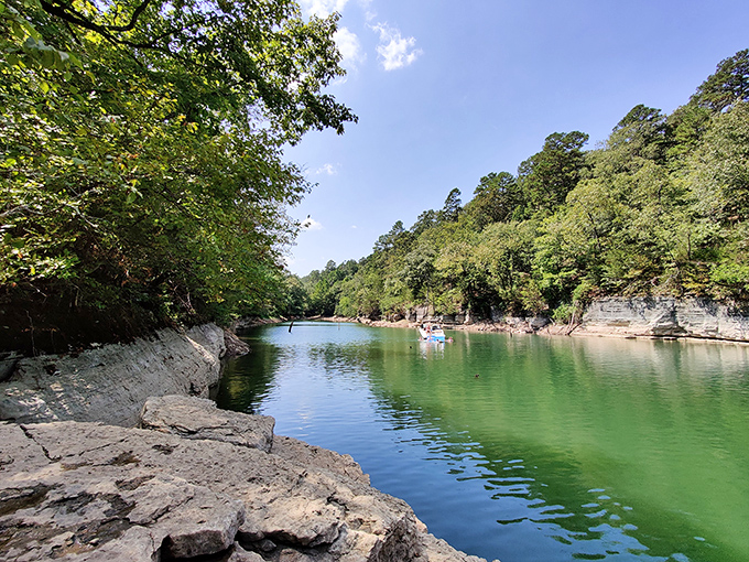 Nature's mirror game is unbeatable here, where autumn-painted limestone bluffs create perfect reflections in waters so clear you'll question which way is up.