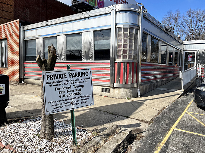 The gleaming stainless steel exterior of Overlea Diner shines like a time machine to the 1950s, complete with those iconic red stripes that practically scream "Come eat with us!"