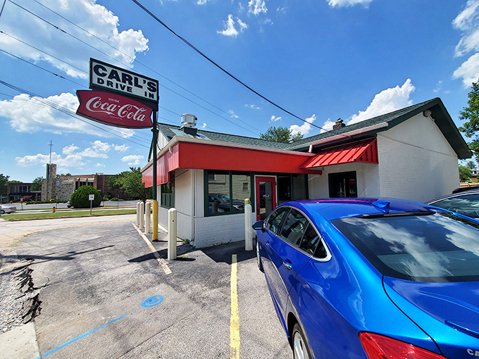 The iconic Carl's Drive-In sign stands like a beacon of burger paradise against the Missouri sky. Some landmarks never need updating.