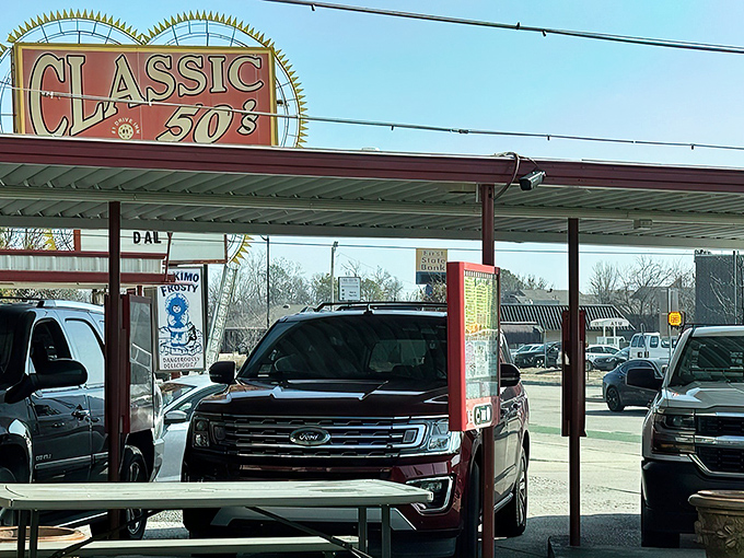 That iconic sunburst sign isn't just advertising&mdash;it's a time machine disguised as a drive-in. The red and white awning beckons like a burger beacon on the horizon.