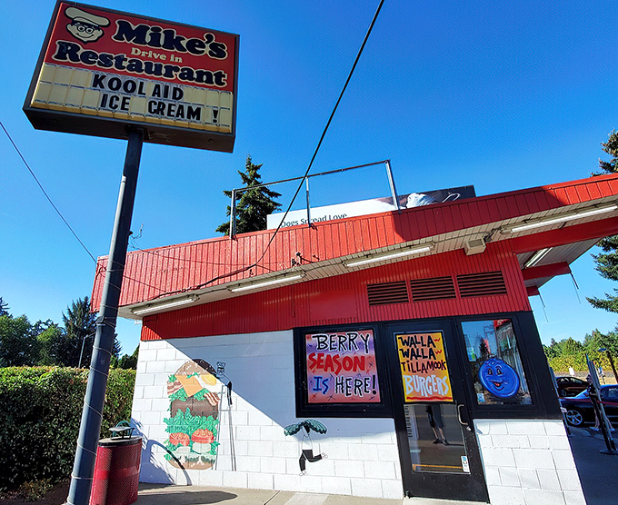 The iconic red and white exterior of Mike's Drive-In stands as a beacon of burger perfection in Milwaukie, welcoming hungry visitors with retro charm. 