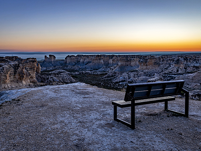 Sunset transforms Little Jerusalem into nature's greatest light show, painting the chalk formations in golden hues while a solitary explorer gains perspective on life's true scale.