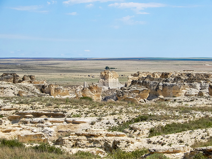 Sunset transforms Little Jerusalem into nature's greatest light show, painting the chalk formations in golden hues while a solitary explorer gains perspective on life's true scale.