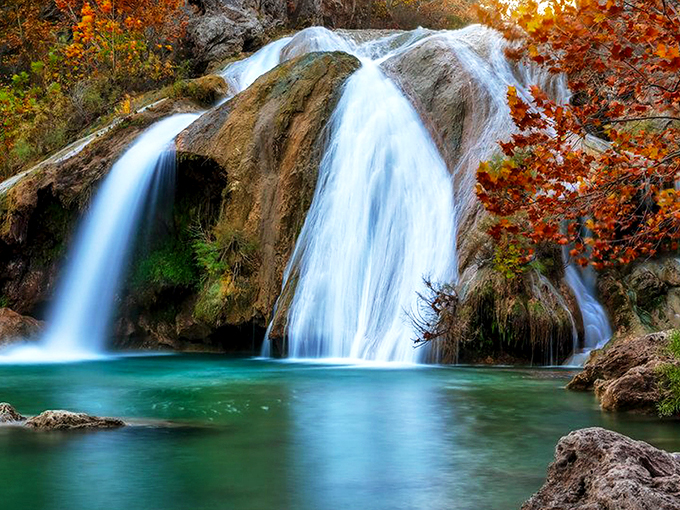 Nature's grand reveal: Turner Falls cascades 77 feet into a turquoise pool that looks like someone smuggled a piece of the Caribbean into Oklahoma. 