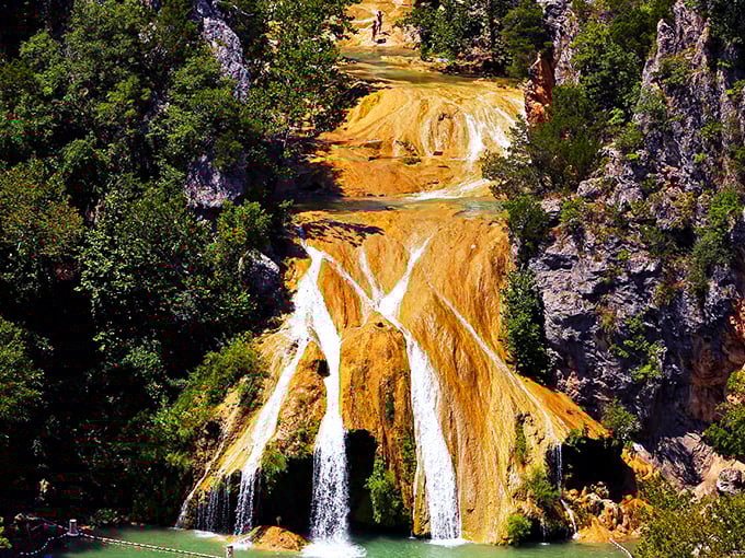 Nature's grand reveal: Turner Falls cascades 77 feet into a turquoise pool that looks like someone smuggled a piece of the Caribbean into Oklahoma. 
