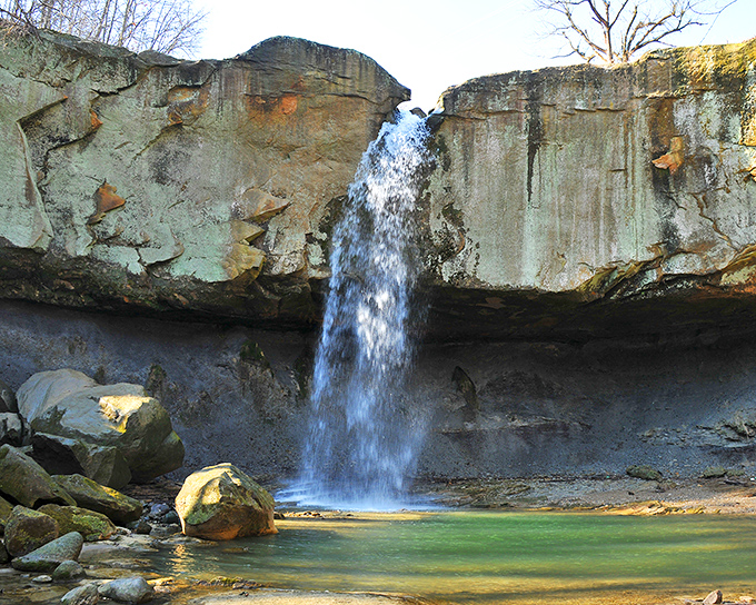 Nature's masterpiece in full display. The 84-foot cascade of Williamsport Falls plunges dramatically between limestone cliffs, creating Indiana's tallest free-falling waterfall spectacle.