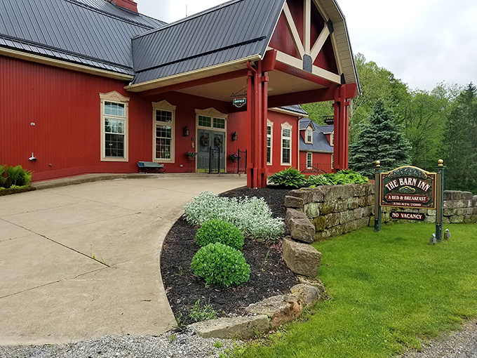 The iconic red exterior of The Barn Inn stands proudly against Ohio's countryside, like a beacon of comfort calling weary travelers home.