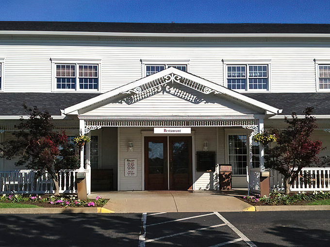The classic white clapboard exterior of Amish Door Restaurant stands like a beacon of comfort food promise against Ohio's big sky.