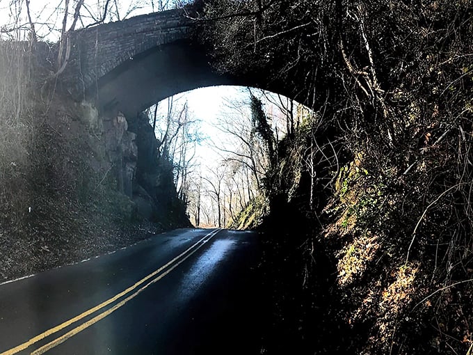 The stone archway of Helen's Bridge emerges from the mist like a portal to another time. Mother Nature's own special effects department working overtime here.