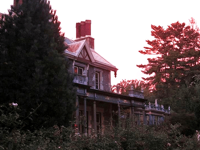 The mansion glows amber against the twilight sky, its stone fa&ccedil;ade and pointed gables silently whispering tales from another century. Like a Victorian ghost story come to life.