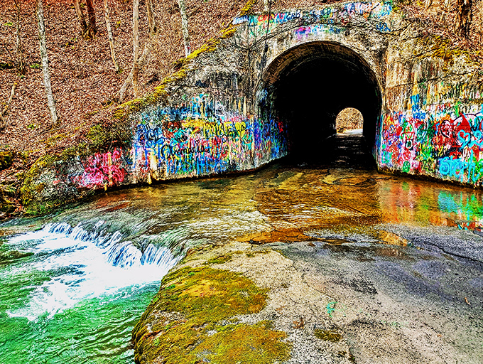 The entrance beckons with an eerie invitation &ndash; colorful graffiti leading into darkness where legends and water converge in Tennessee's most notorious tunnel.