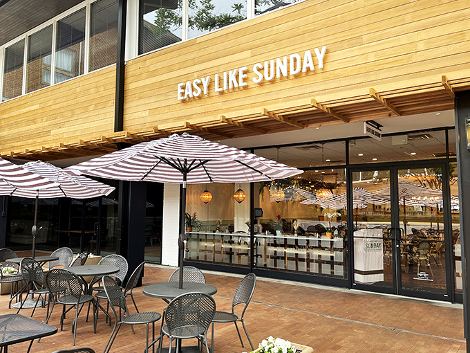 The golden wooden facade of Easy Like Sunday beckons like a sunrise, promising brunch dreams under those cheerfully striped umbrellas. Baltimore's answer to European cafe culture.