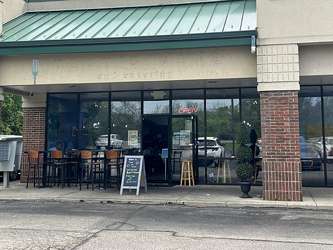 The unassuming storefront might fool you, but that chalkboard sign is basically a treasure map to breakfast nirvana.