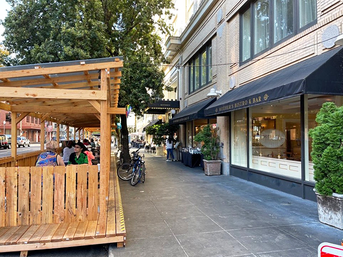 The corner storefront beckons like an old friend, promising comfort with its elegant awning and warm glow from within. Portland's downtown treasure awaits