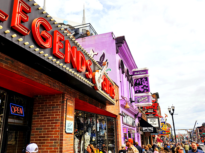 The iconic red Legends Gifts storefront beckons like a siren song to Nashville visitors. That guitar silhouette isn't just decoration&mdash;it's a promise of melodious treasures within. 